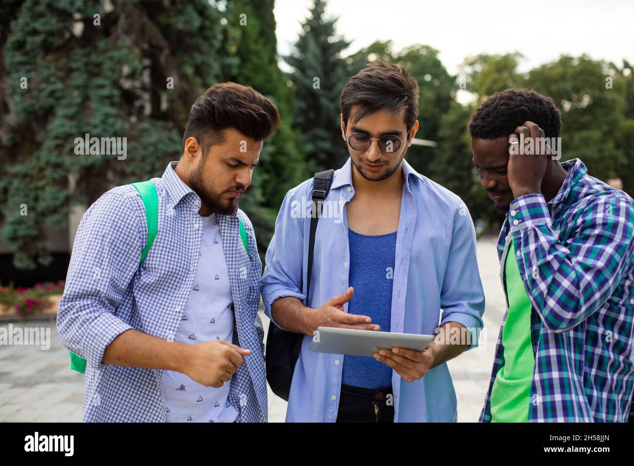The group of indian students help your classmate with navigation Stock ...