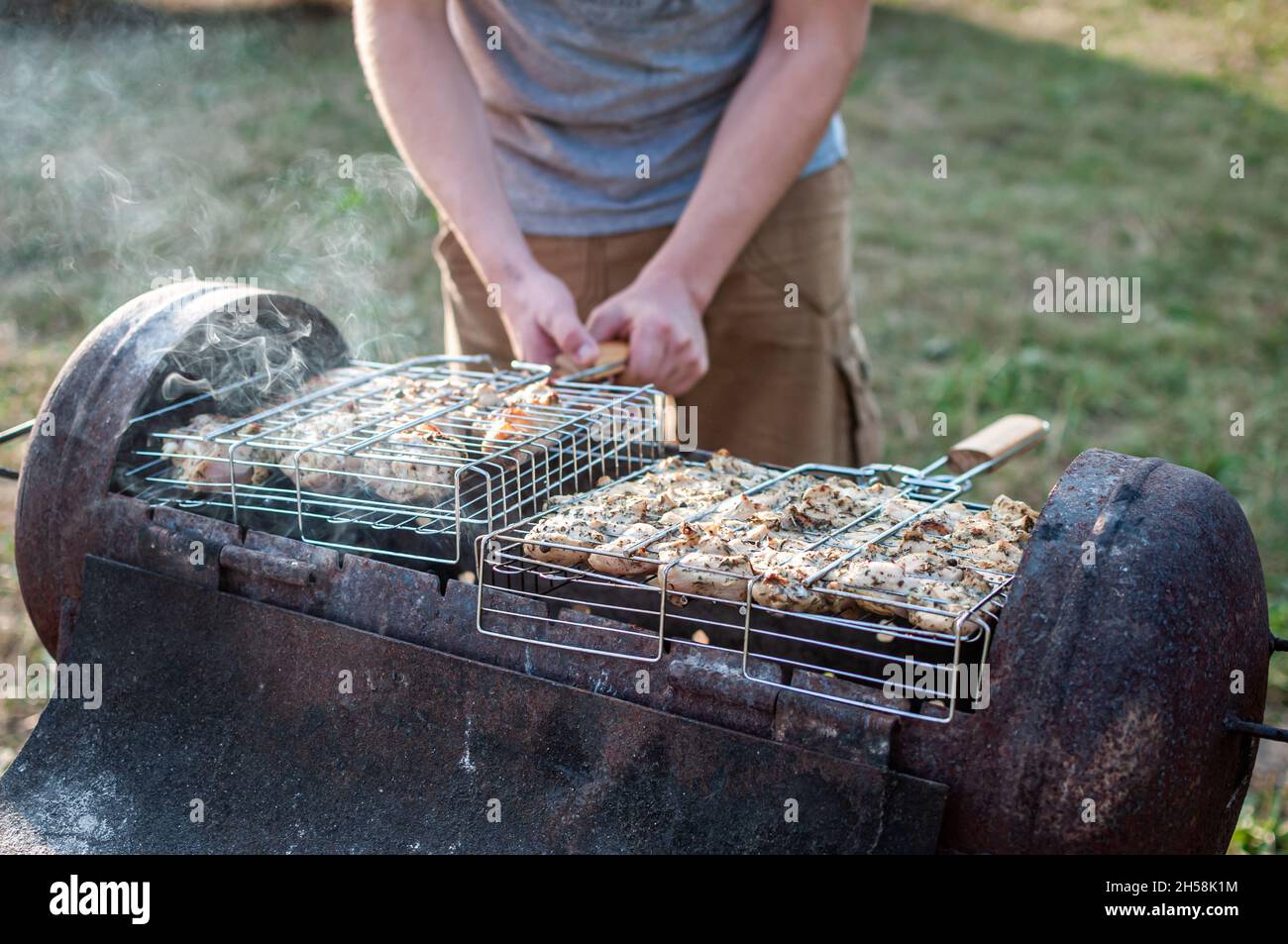 grilled meat skewers chicken the meat holder over fire burned churcoal ...