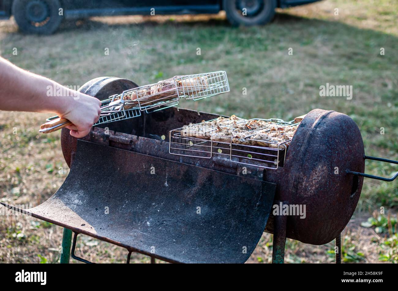 grilled meat skewers chicken the meat holder over fire burned churcoal ...