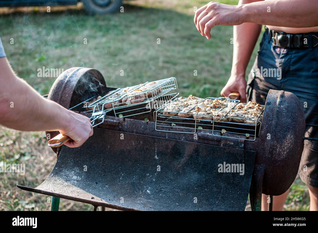 grilled meat skewers chicken the meat holder over fire burned churcoal ...