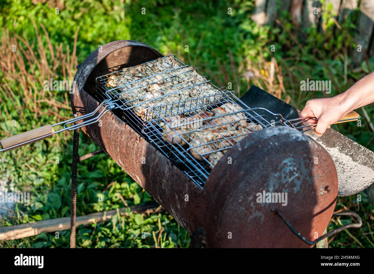 grilled meat skewers chicken the meat holder over fire burned churcoal ...