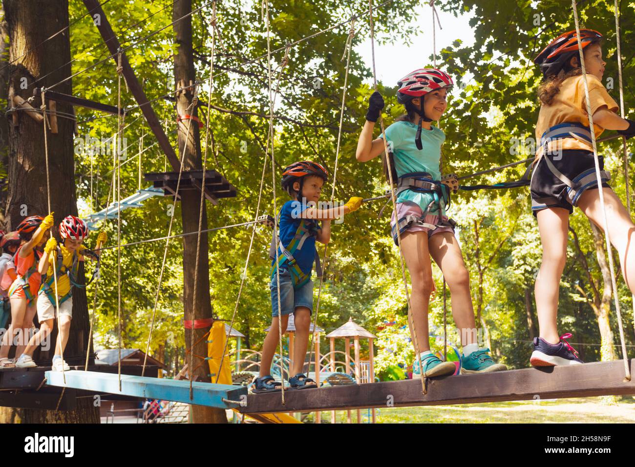 The concentrated kids are climbing in the high rope park Stock Photo ...
