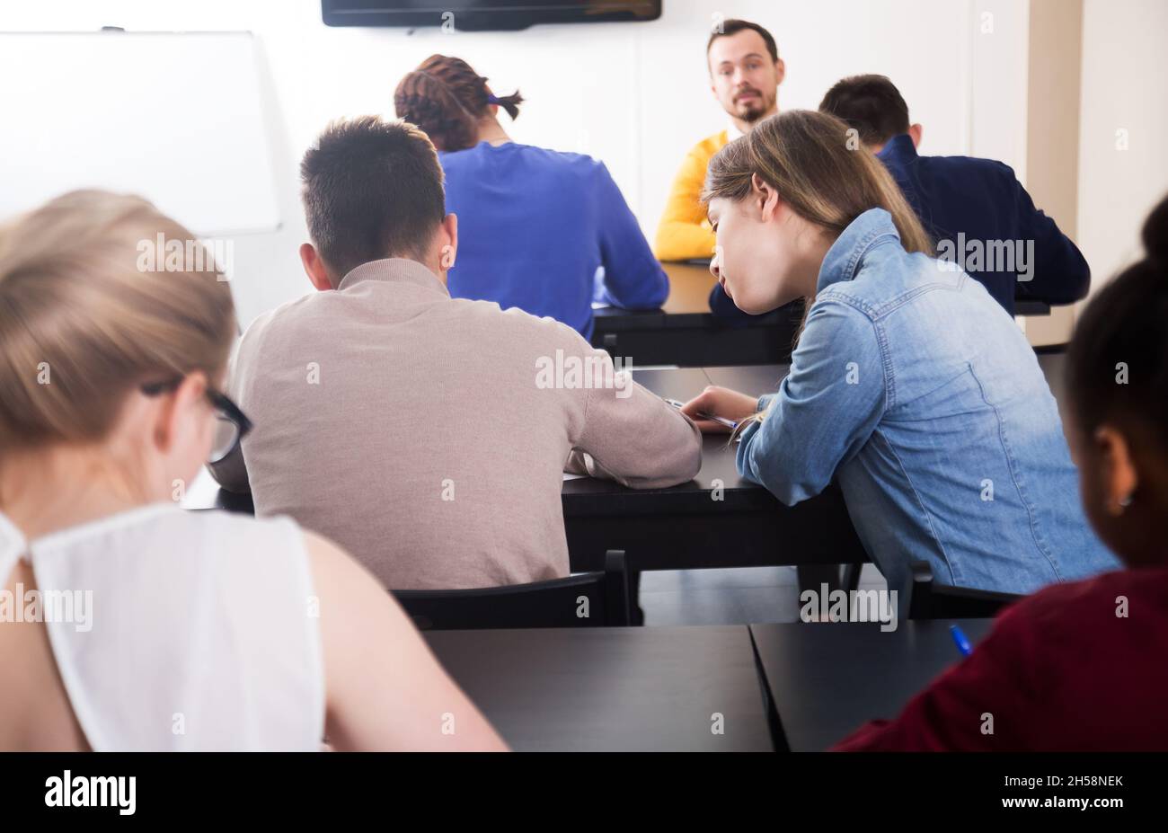 Students listening to teacher Stock Photo - Alamy