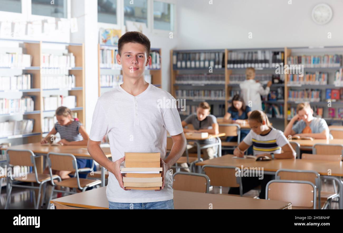 Boy studying pile of books hi-res stock photography and images - Alamy