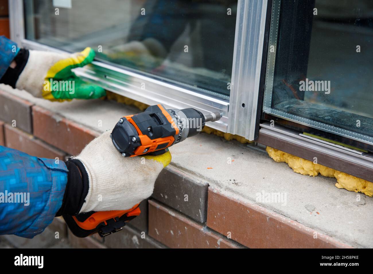 The wizard is engaged in installing windows. Repair work Stock Photo ...