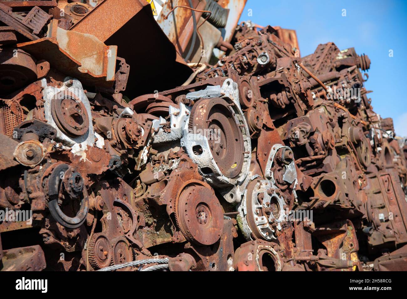 Piles of scrap internal combustion engines stacked in a scrap yard ...