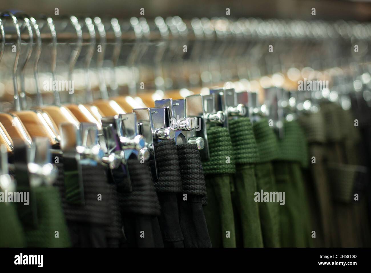 Pants in the store on hangers. Details of the clothing store. Placement ...