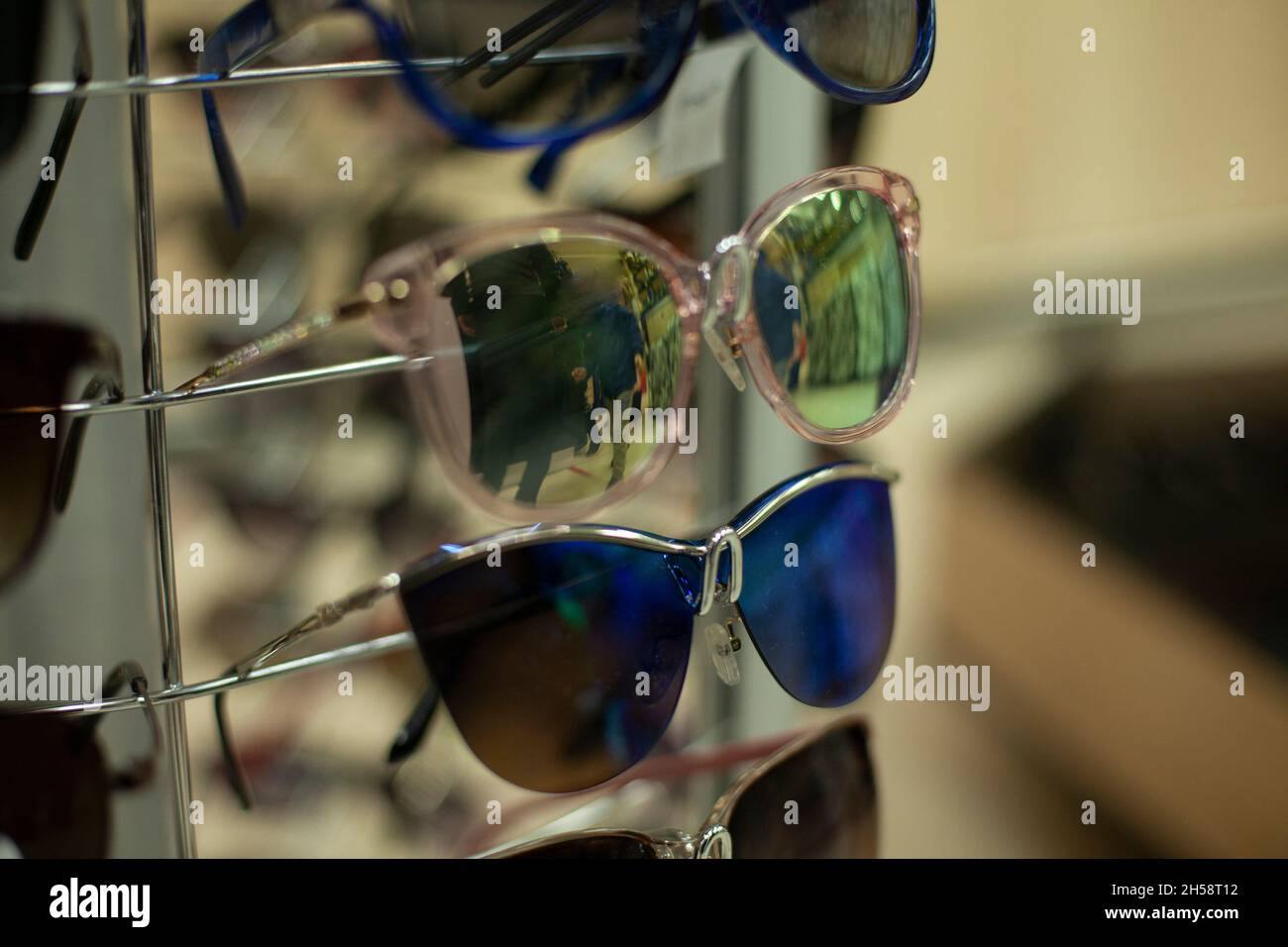 Lots of glasses in the store. Sunglasses on sale. Stand with glasses to ...