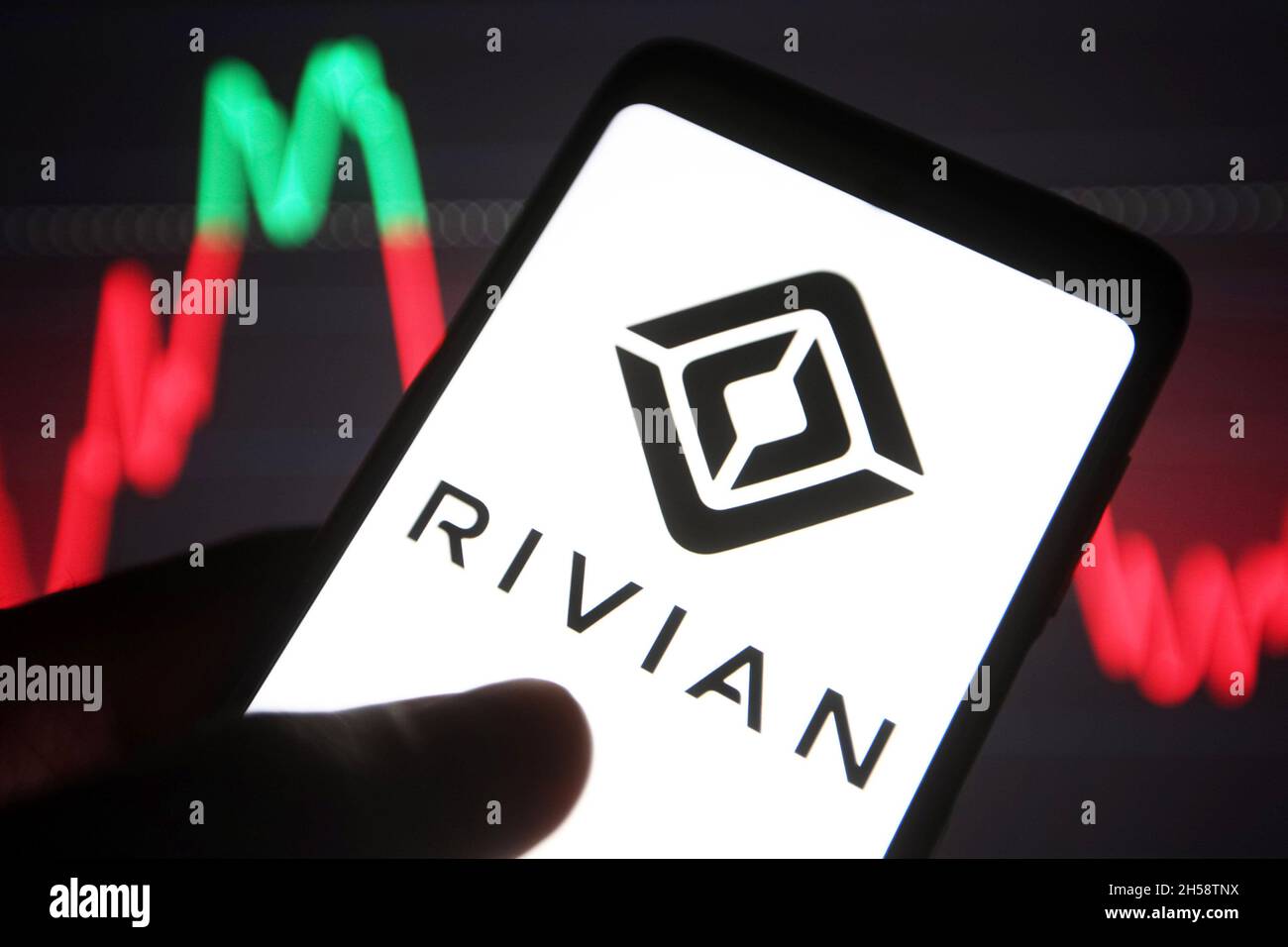 In this photo illustration, a Rivian Automotive LLC logo of an electric ...