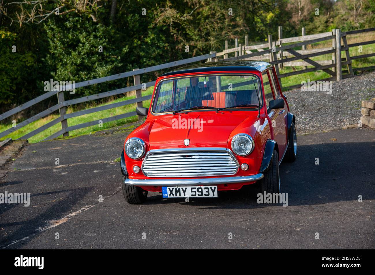 classic Austin Mini parked on a gravel drive in a rural farm setting ...