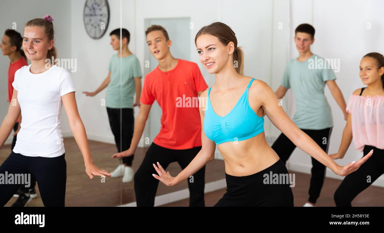 Female coach training dance with teenagers Stock Photo - Alamy