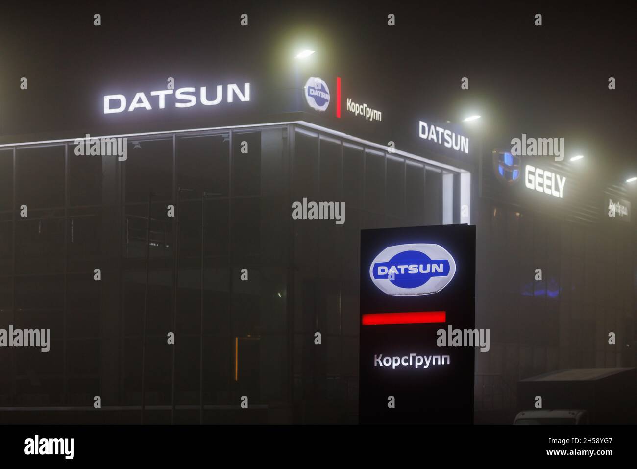Datsun logo on car dealership building at foggy night - Datsun is an ...