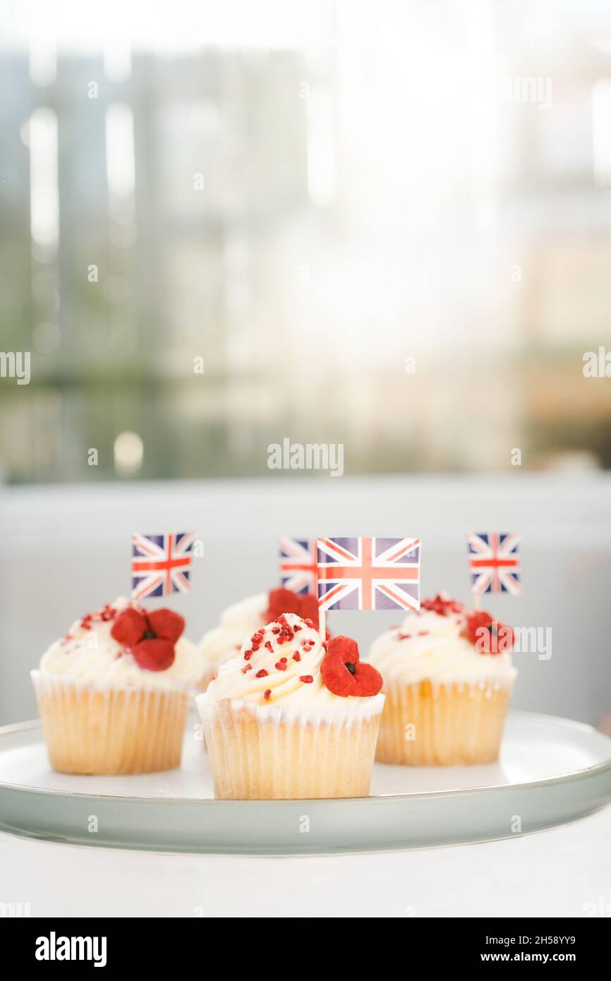 Cupcake with British Union jack flag and poppy flower. Remembrance Day ...