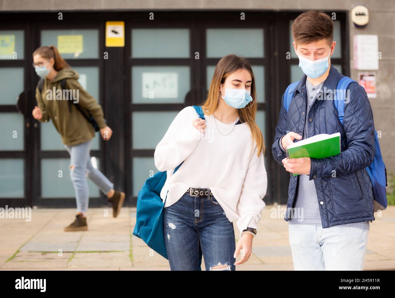 Teenagers in masks friendly talking outside Stock Photo - Alamy