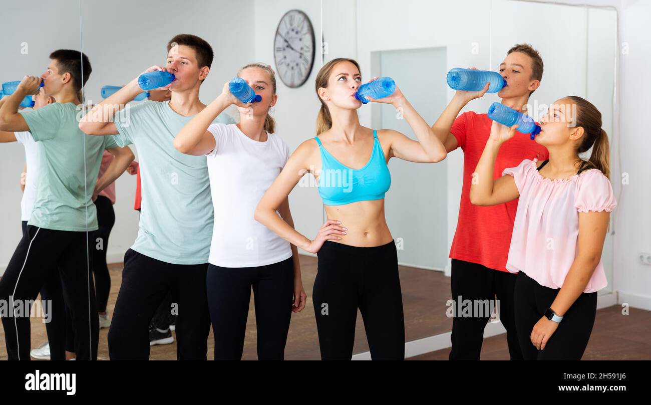 Teenagers drinking water during break in dance class Stock Photo - Alamy