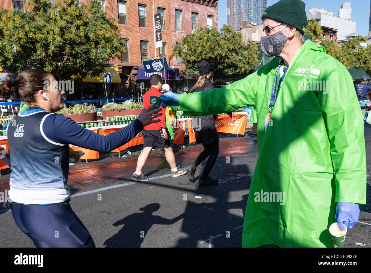 A volunteer hands Gatorade to a runner of the 50th TSC New York City ...