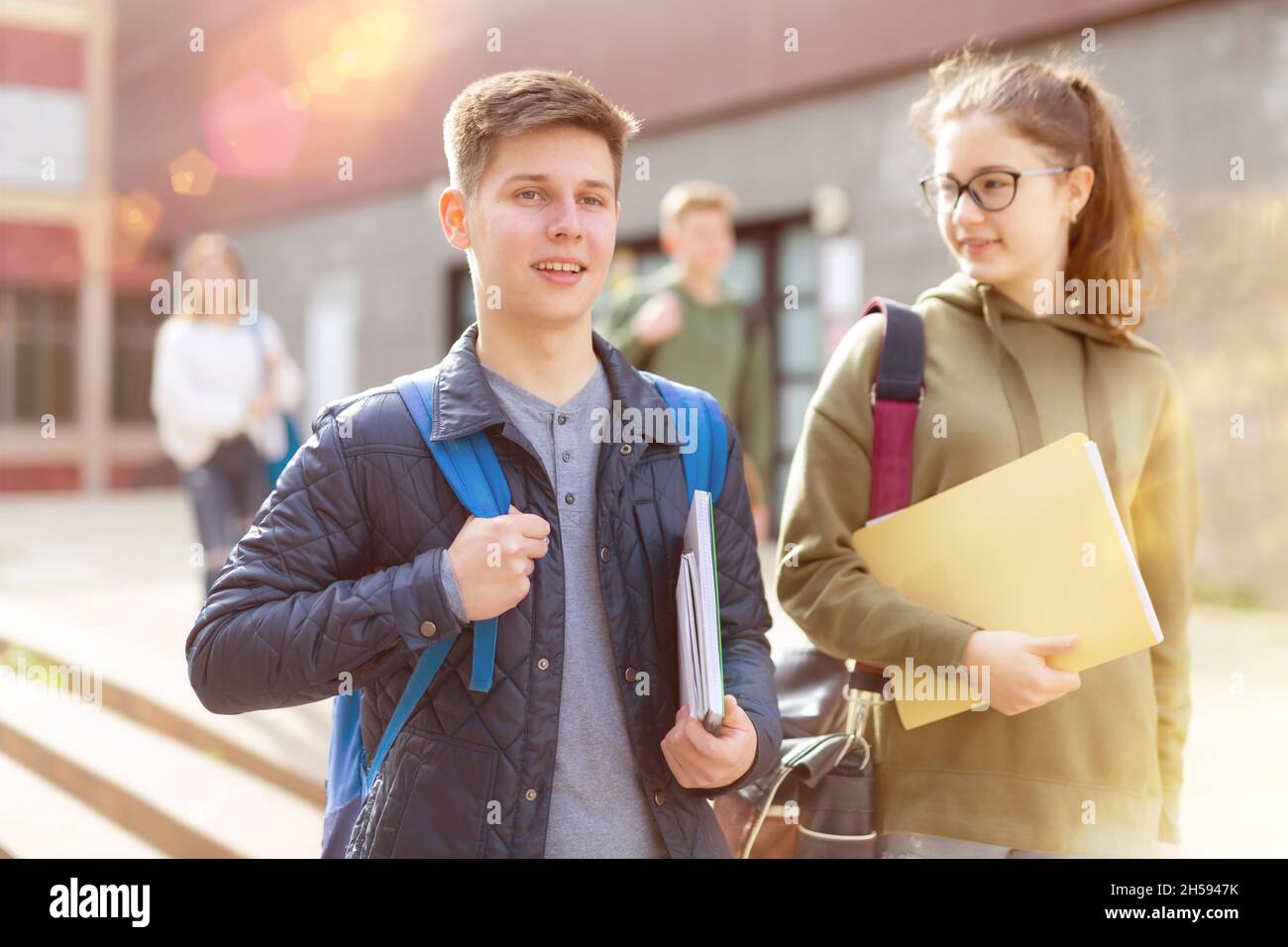 Carefree teen students boy and girl friendly talking Stock Photo - Alamy
