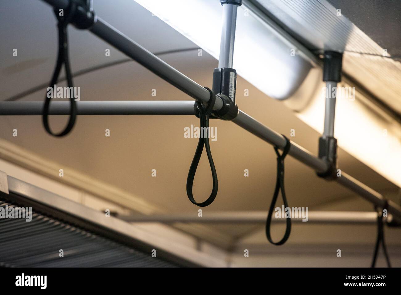Picture of a grab handle in a suburban train, inside, with nobody ...