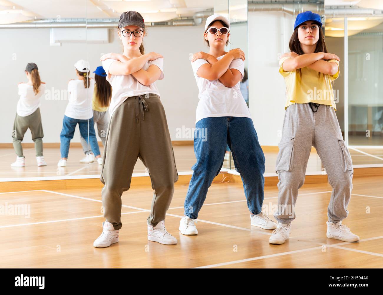 Three slender girls dancing in hip hop dance studio Stock Photo - Alamy