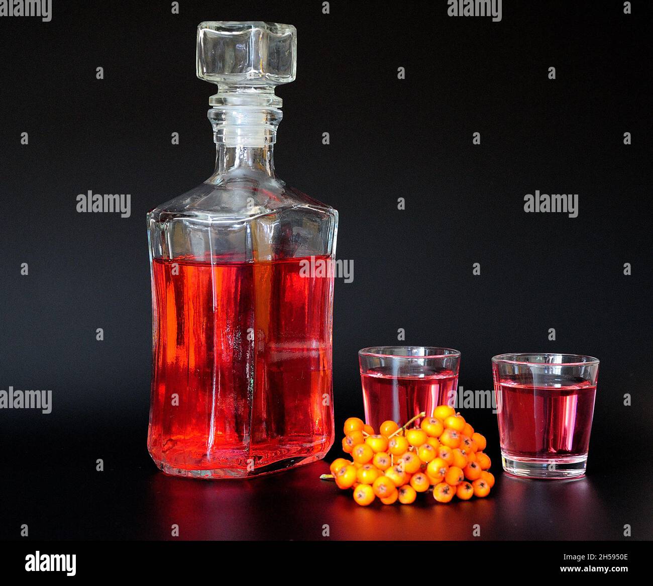 Homemade liqueur on mountain ash, strong alcohol in a glass bottle and ...