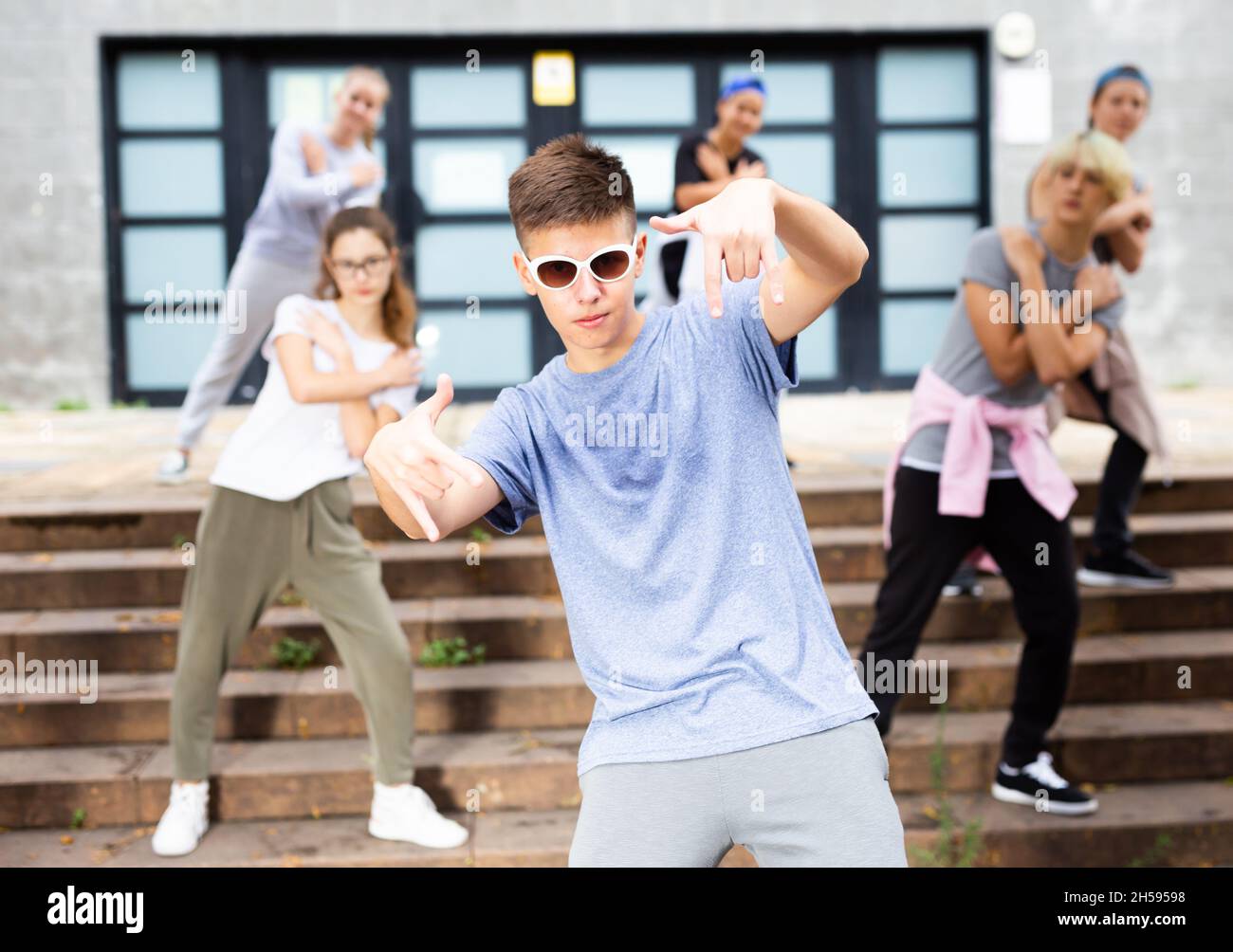 Modern teenager performing street dance with group Stock Photo - Alamy