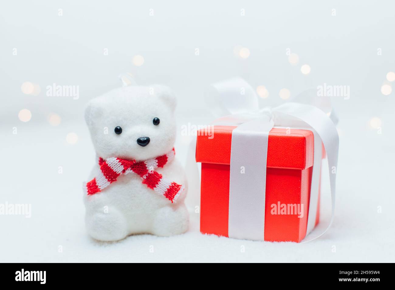 White polar bear toy with scarf and red present box with white ribbon ...