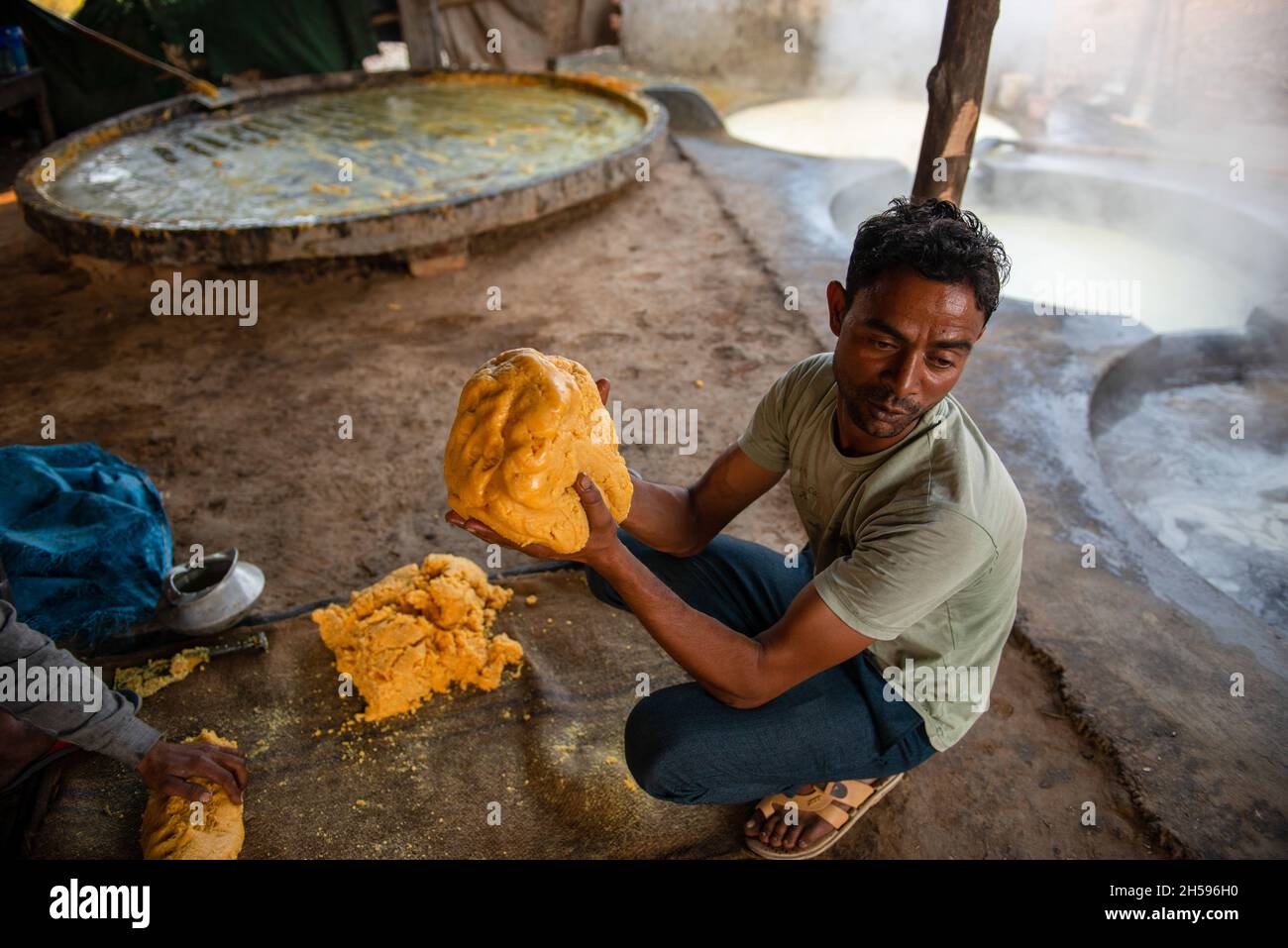 Roorkee, India. 06th Nov, 2021. A worker shows a jaggery round ball ...