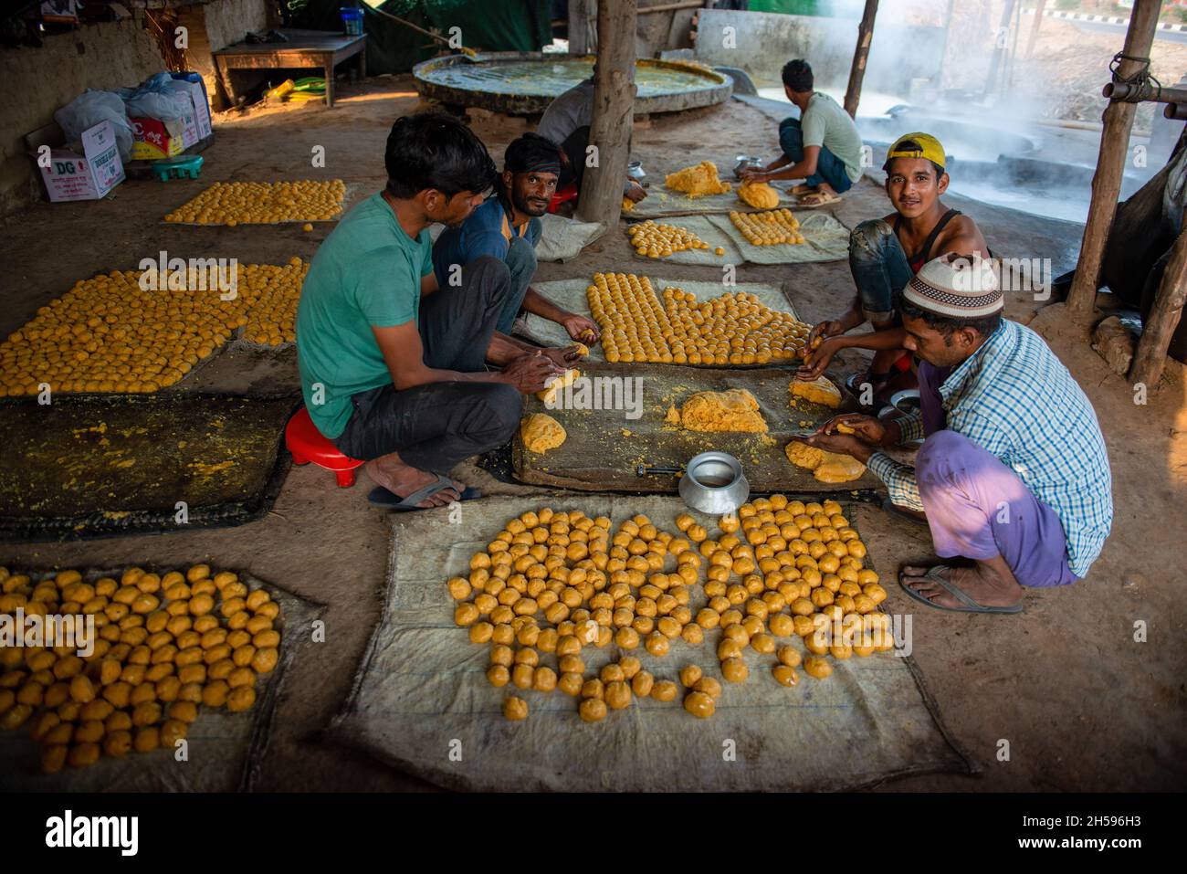 Roorkee, India. 06th Nov, 2021. Workers prepare jaggery round balls for ...