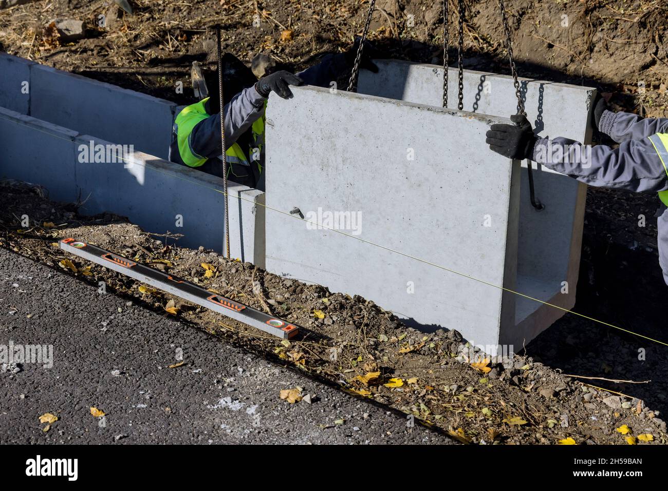 Road worker mounting U-ditch, U-shaped water channel construction Stock ...