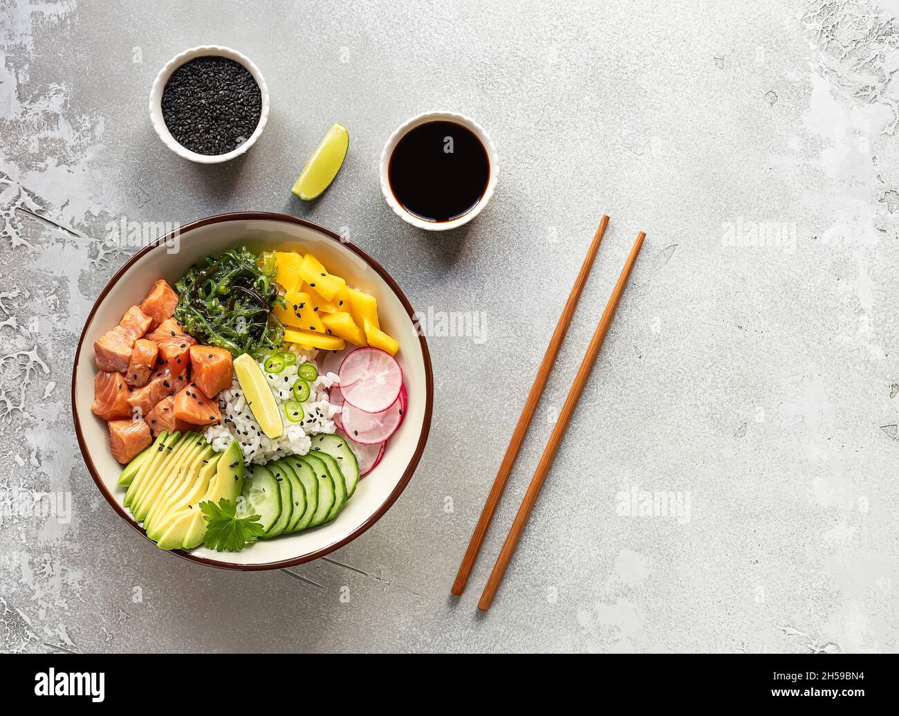 Hawaiian salmon fish poke bowl with rice, mango, radish, cucumber ...