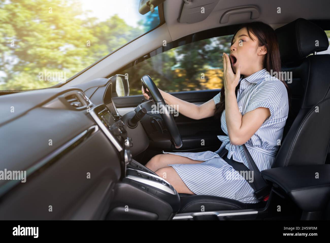 tired woman yawning and sleepy while driving a car Stock Photo - Alamy