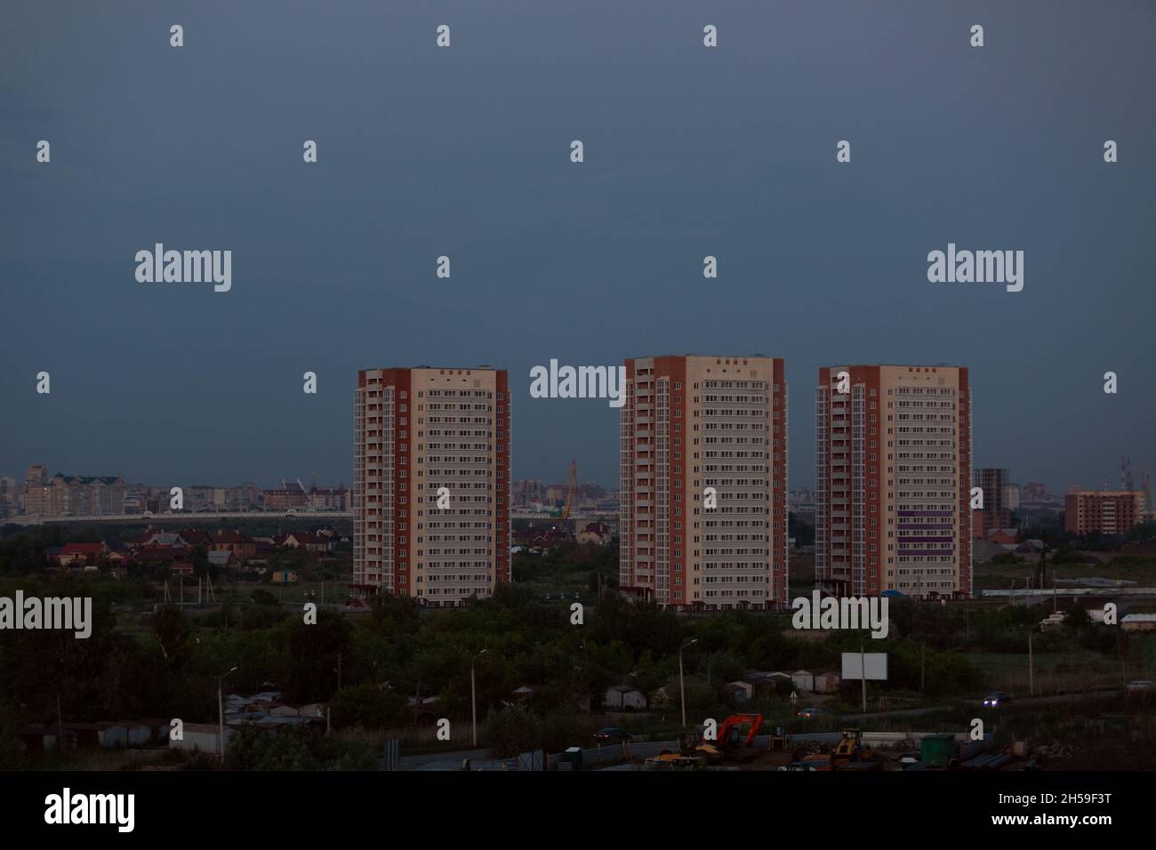 Modern city view with skyscraper buildings at evening time. three multi ...