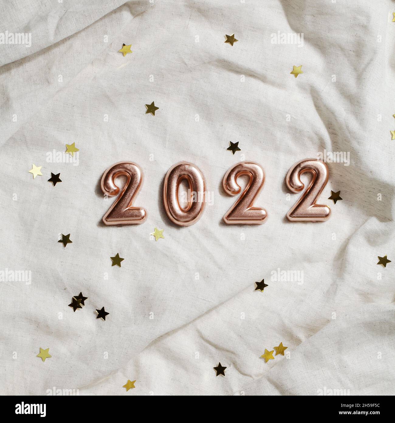 numbers 2022 on grey crumpled textiles. top view new year celebration ...