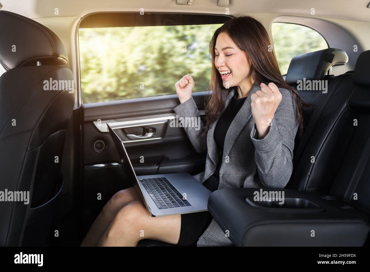 successful young business woman using laptop computer while sitting in ...