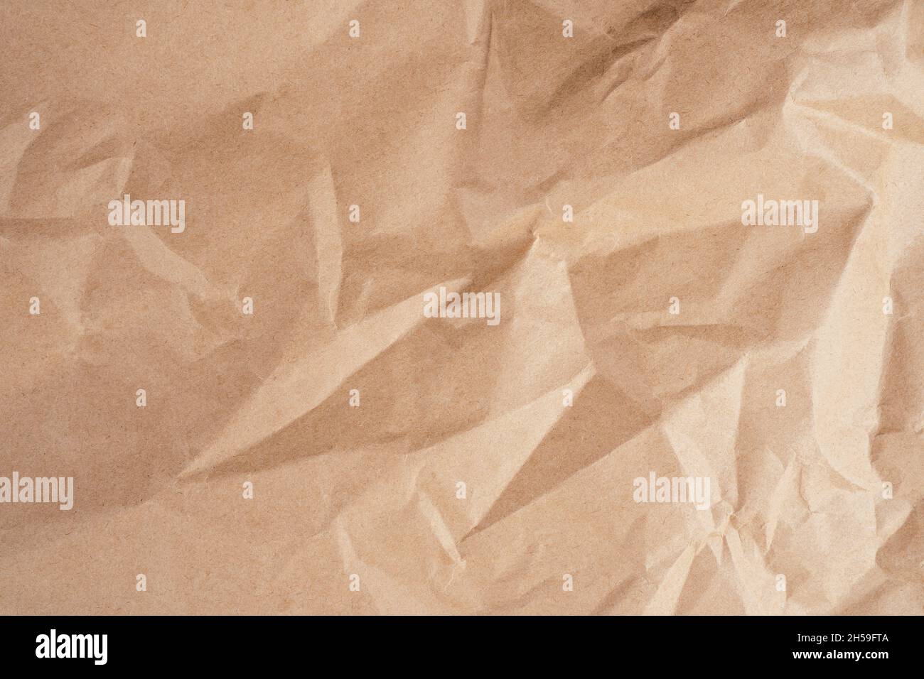Background image of rough crumpled recycled textured kraft paper. Top ...