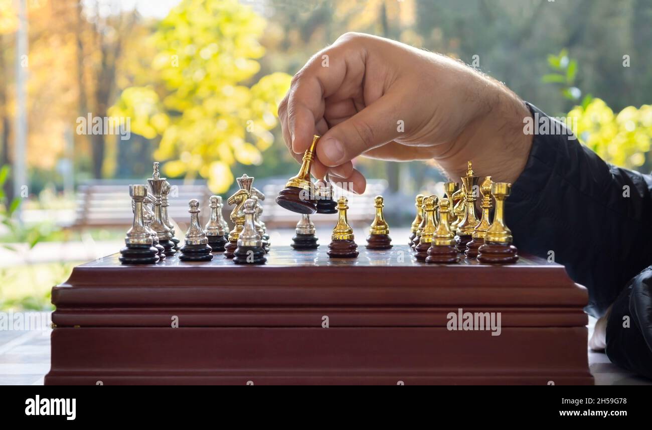 A man's hand removes the opponent's figure in a chess game. Checkmate ...