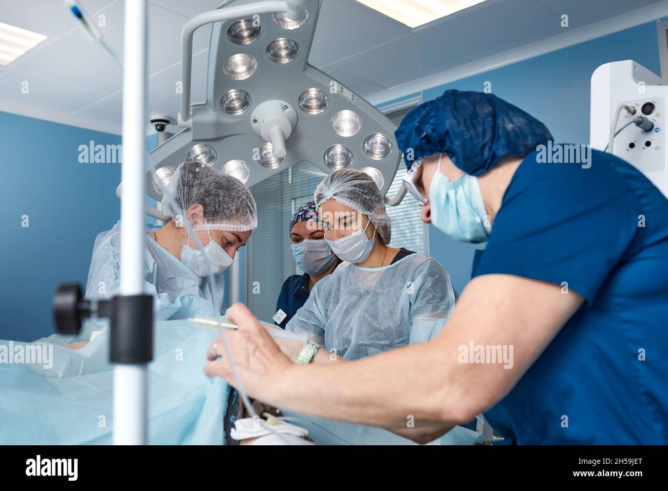 Concentrated Surgical team operating a patient in an operation theater ...