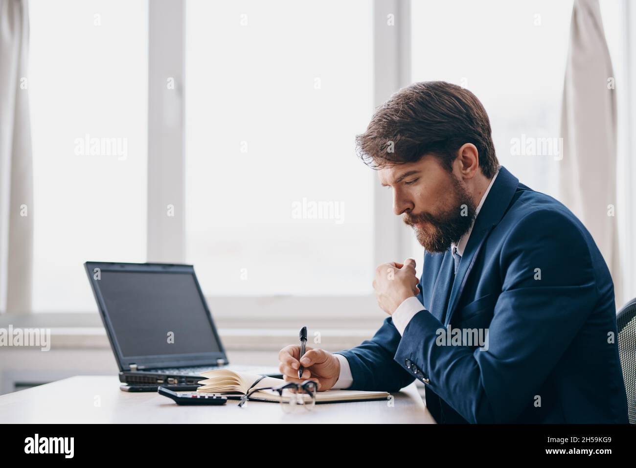 businessmen at the table in front of a laptop communication ...