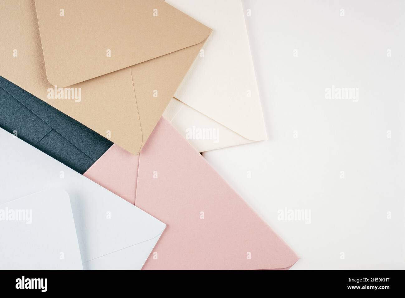 Background image of multi-colored cardboard envelopes lying randomly on ...