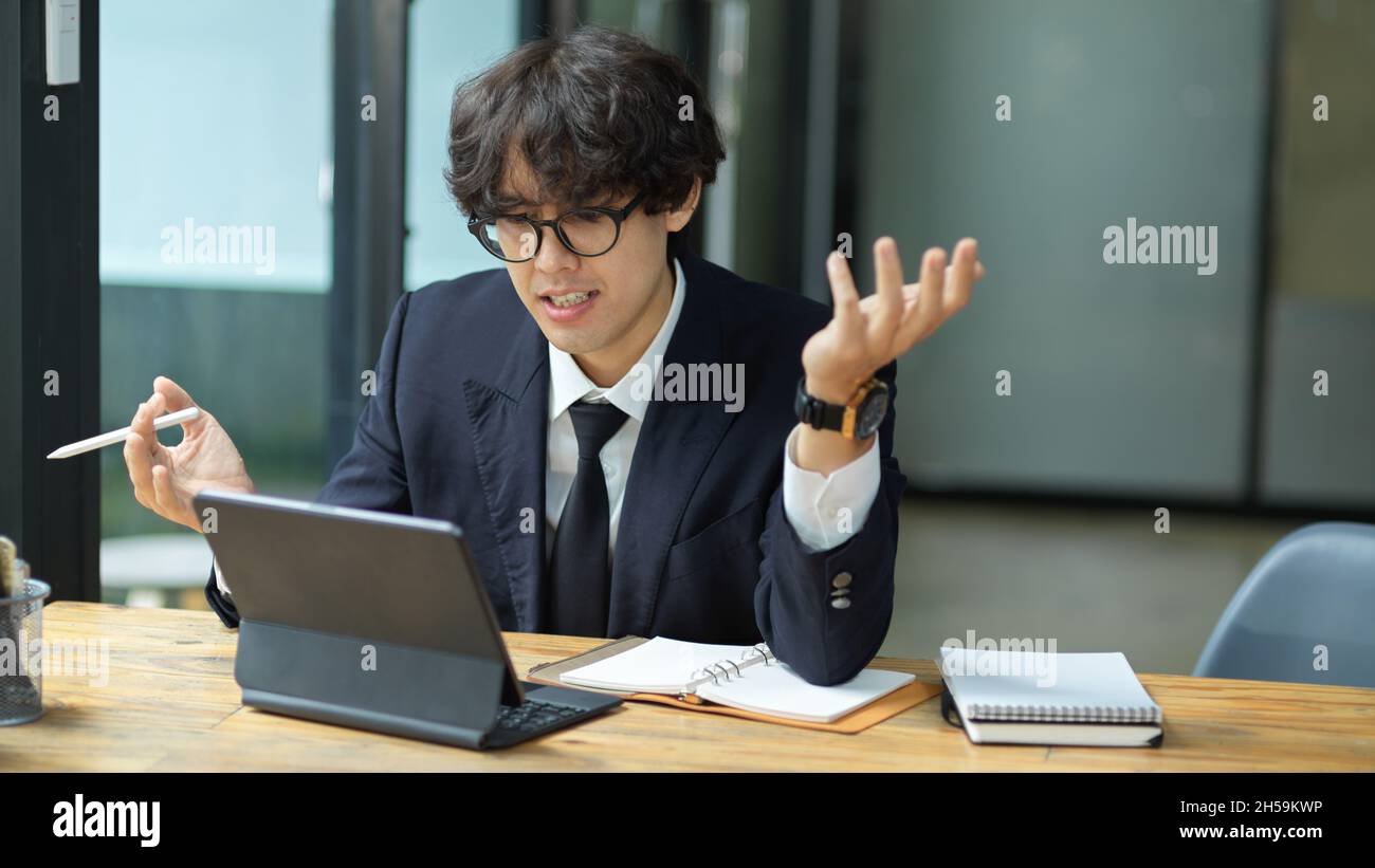 An executive businessman conducts an online consultation with board ...