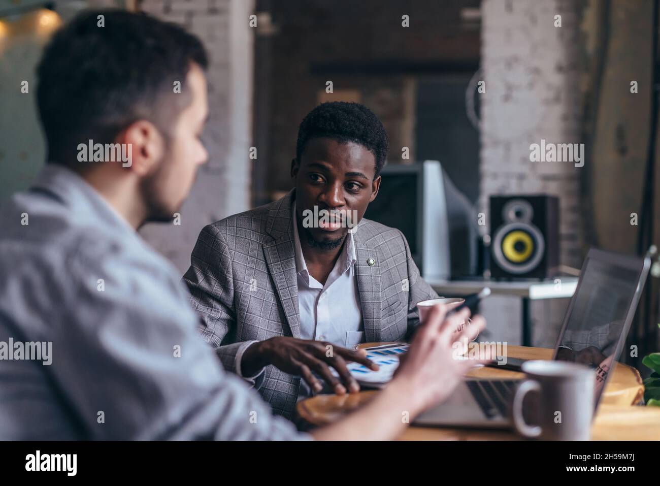 Two business partners working with laptop together Stock Photo - Alamy