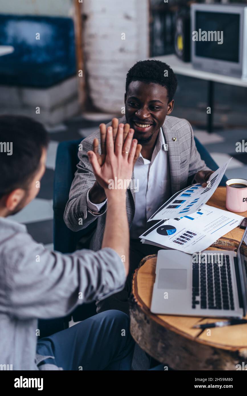 Happy employees giving high hi-res stock photography and images - Alamy