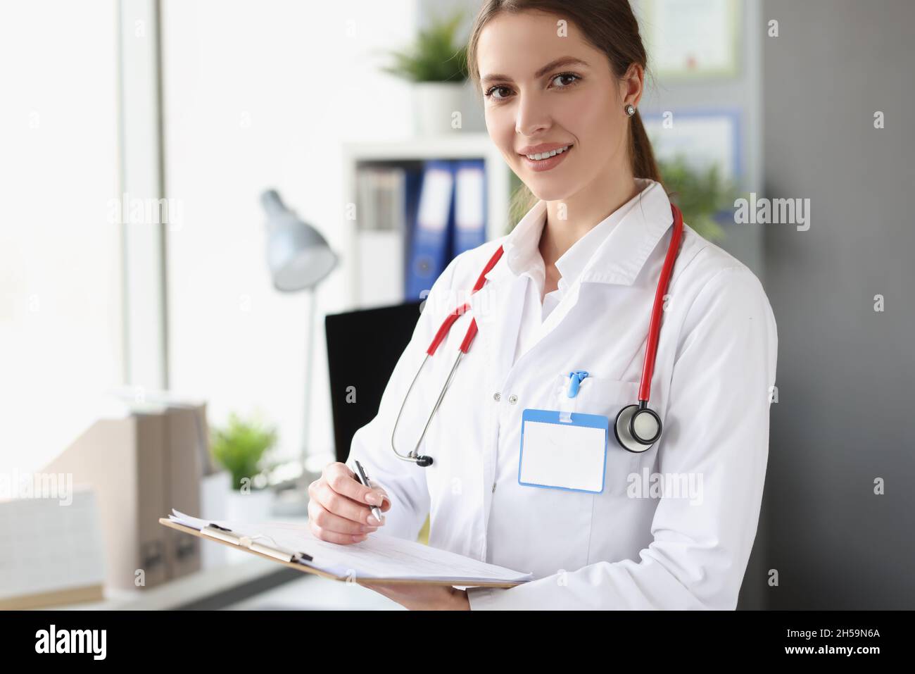 Female doctor posing in clinic Stock Photo - Alamy