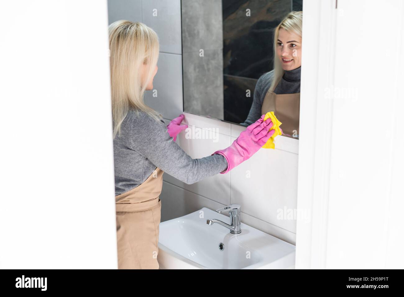 Woman wiping mirror housework hi-res stock photography and images - Alamy