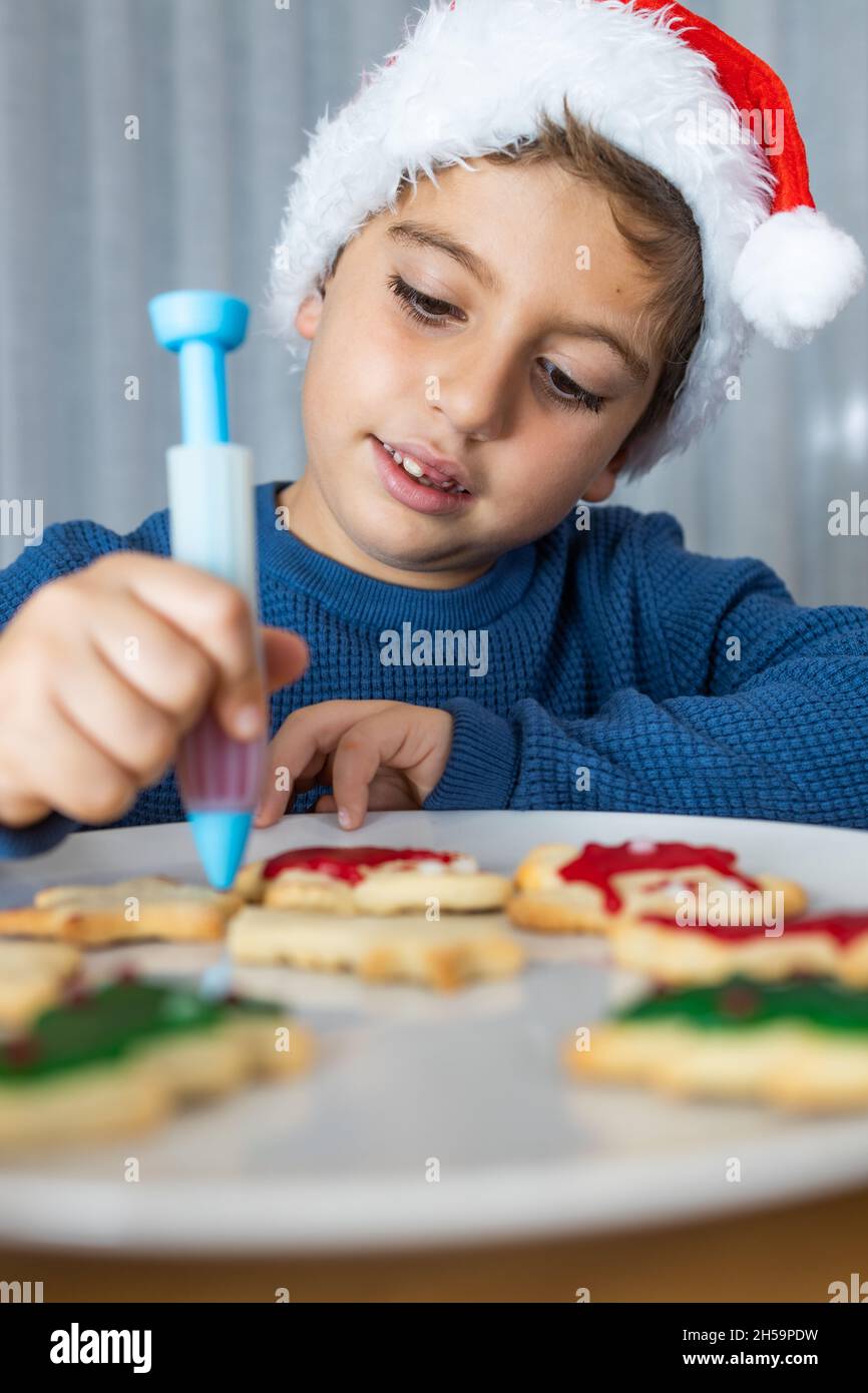 Boy decorating biscuit hi-res stock photography and images - Alamy