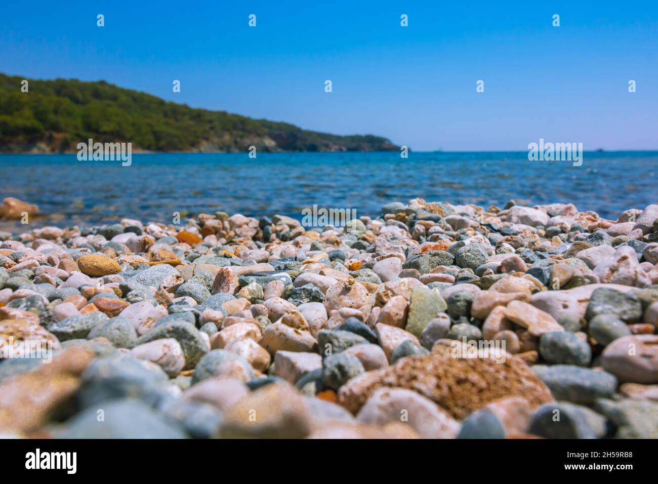 Pebbles on the beach and sea on the background. Summer vacation ...