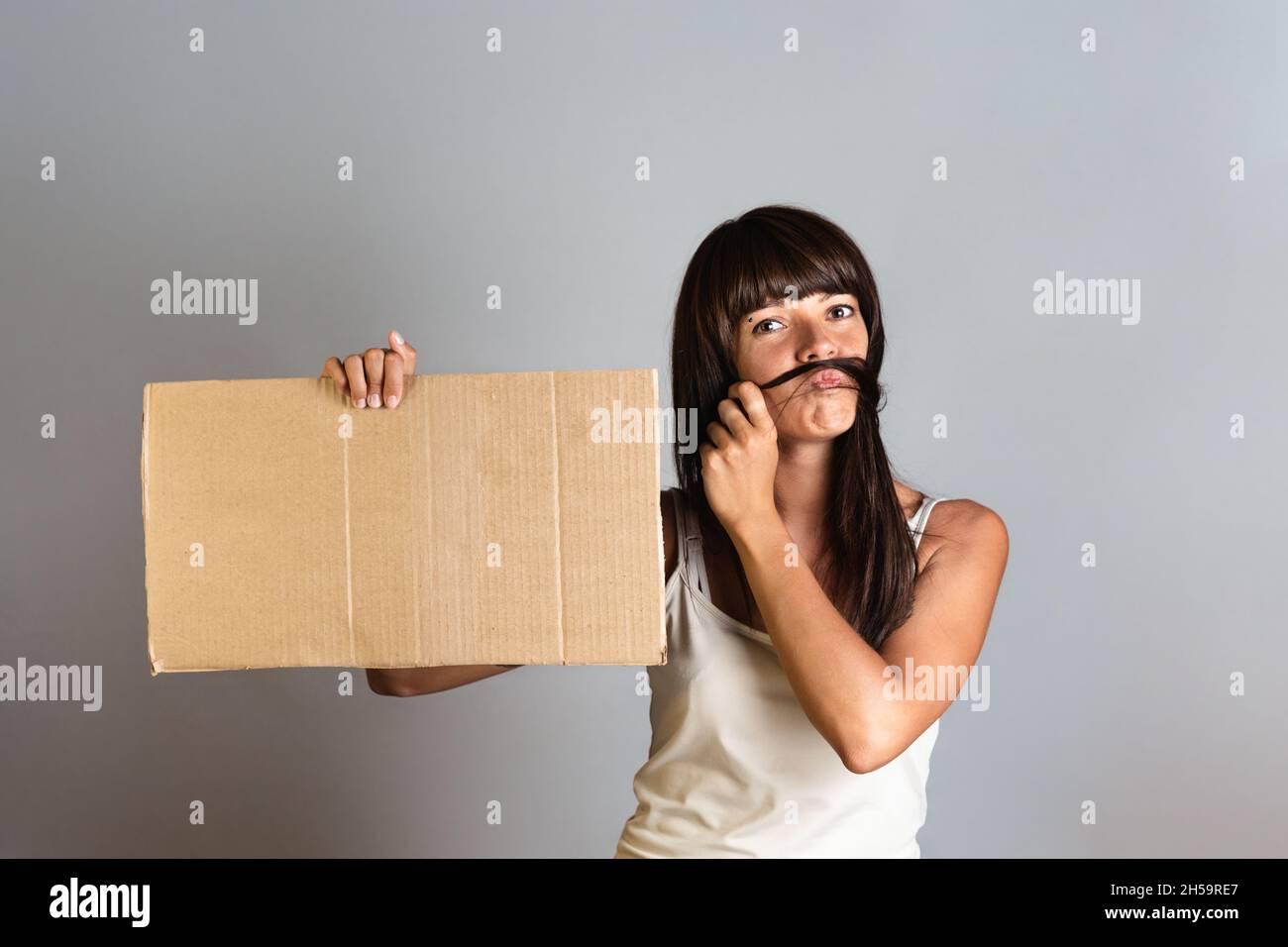 The concept of feminism and women's rights. A woman holds a cardboard ...