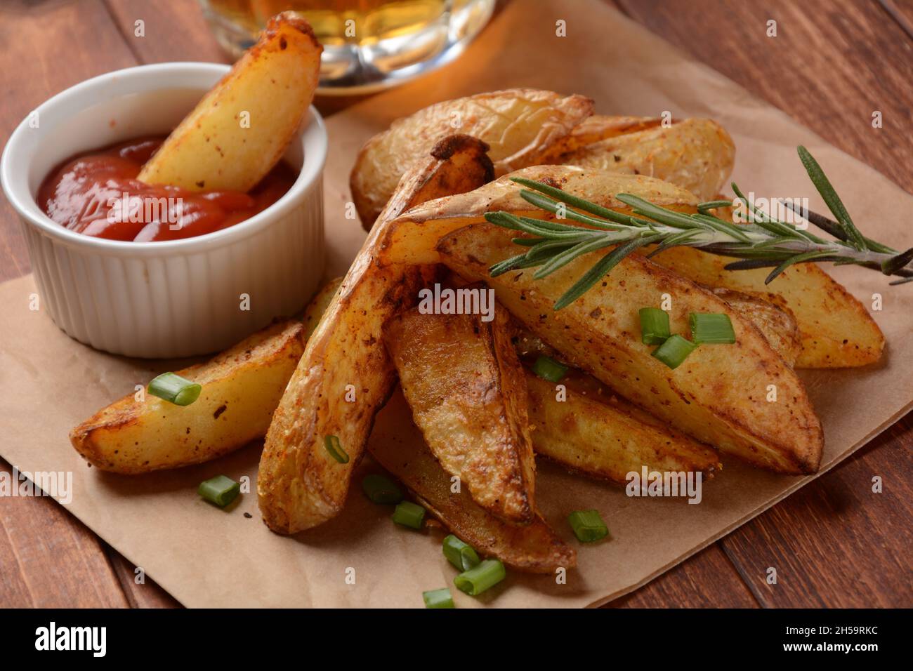 Baked, fried potato wedges with spices and rosemary Stock Photo - Alamy