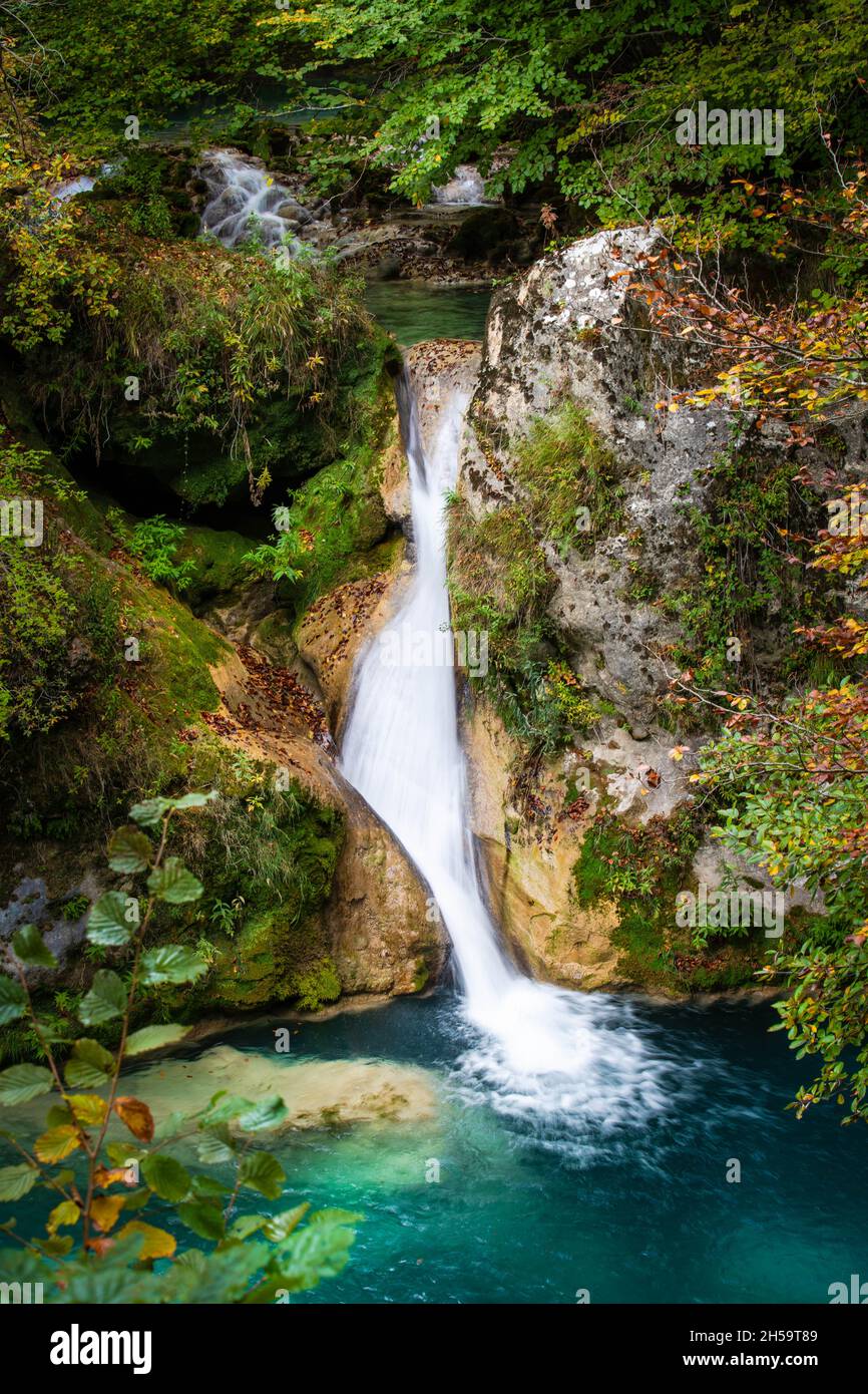 Forest turquoise blue lake with white marble stones and waterfalls in ...