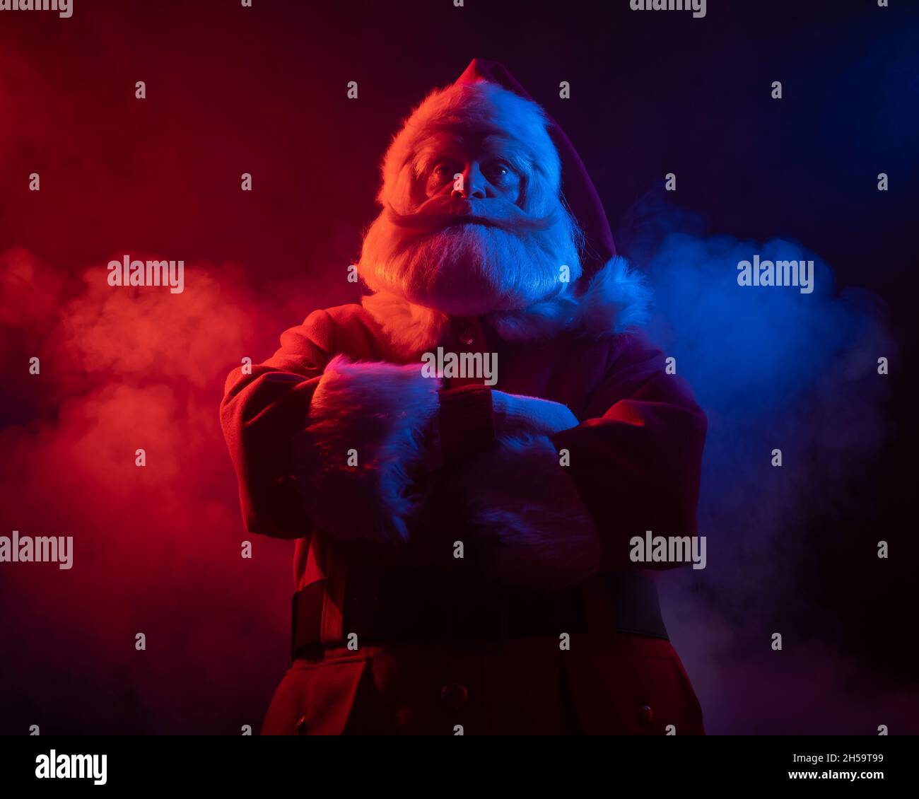 Santa claus in blue red smoke. Party for Christmas Stock Photo - Alamy